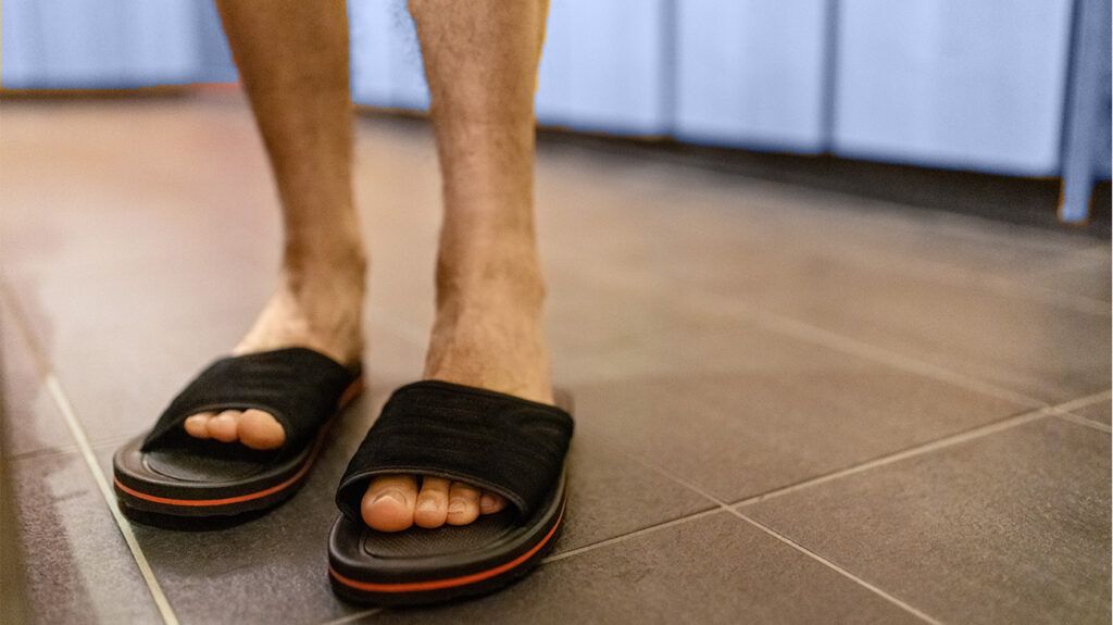 Why might red spots appear on the feet of a person with diabetes?