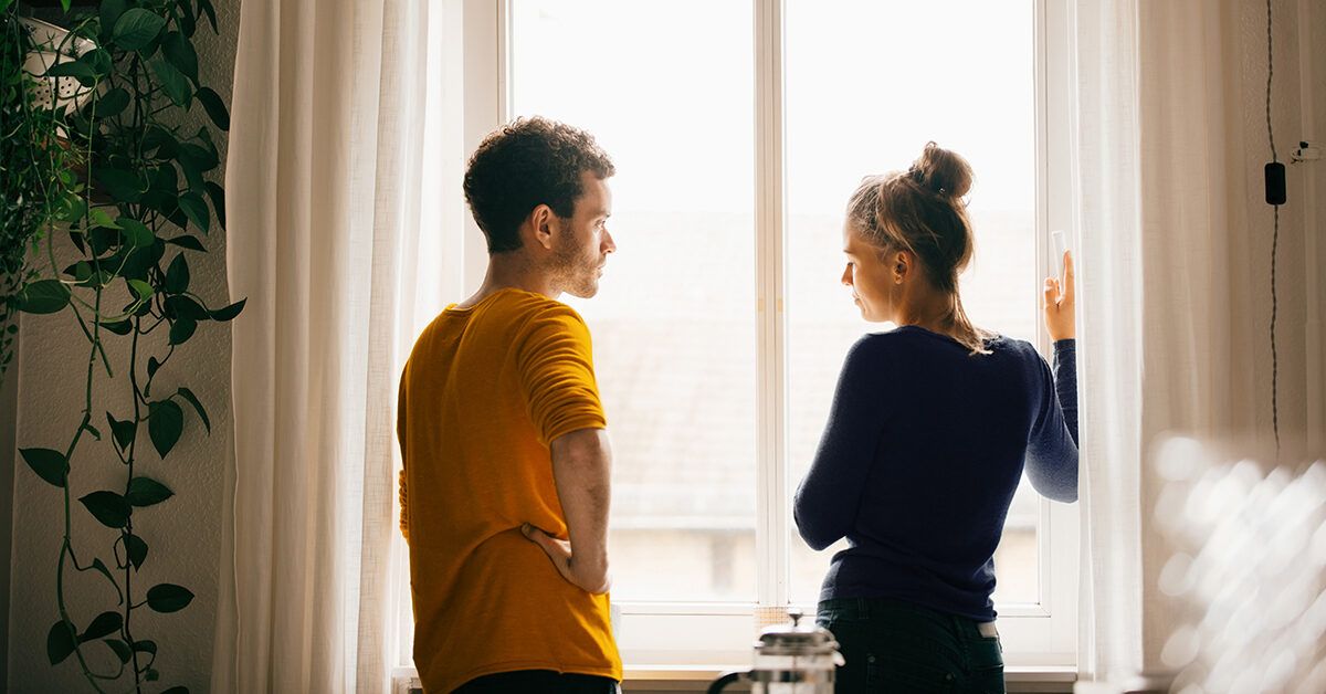 Woman Standing Over Man
